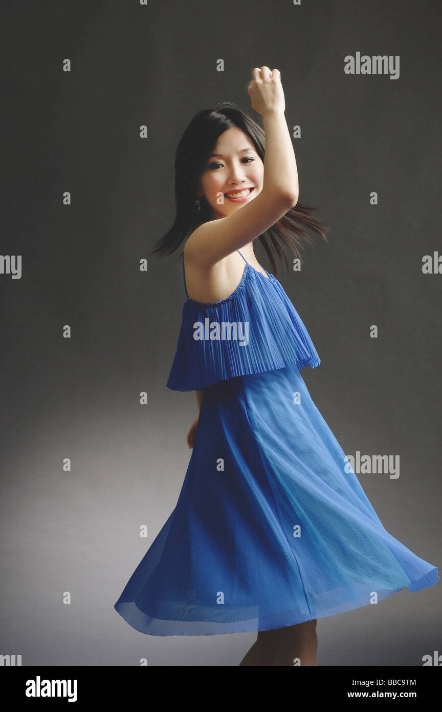 Woman in blue dress, spinning Stock Photo - Alamy