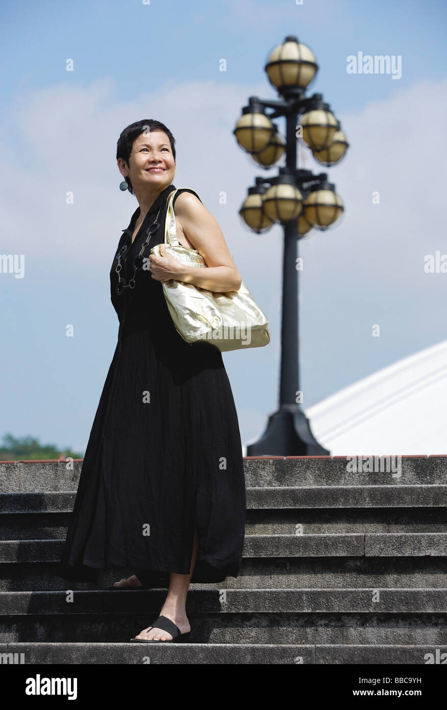 Woman walking down steps Stock Photo - Alamy