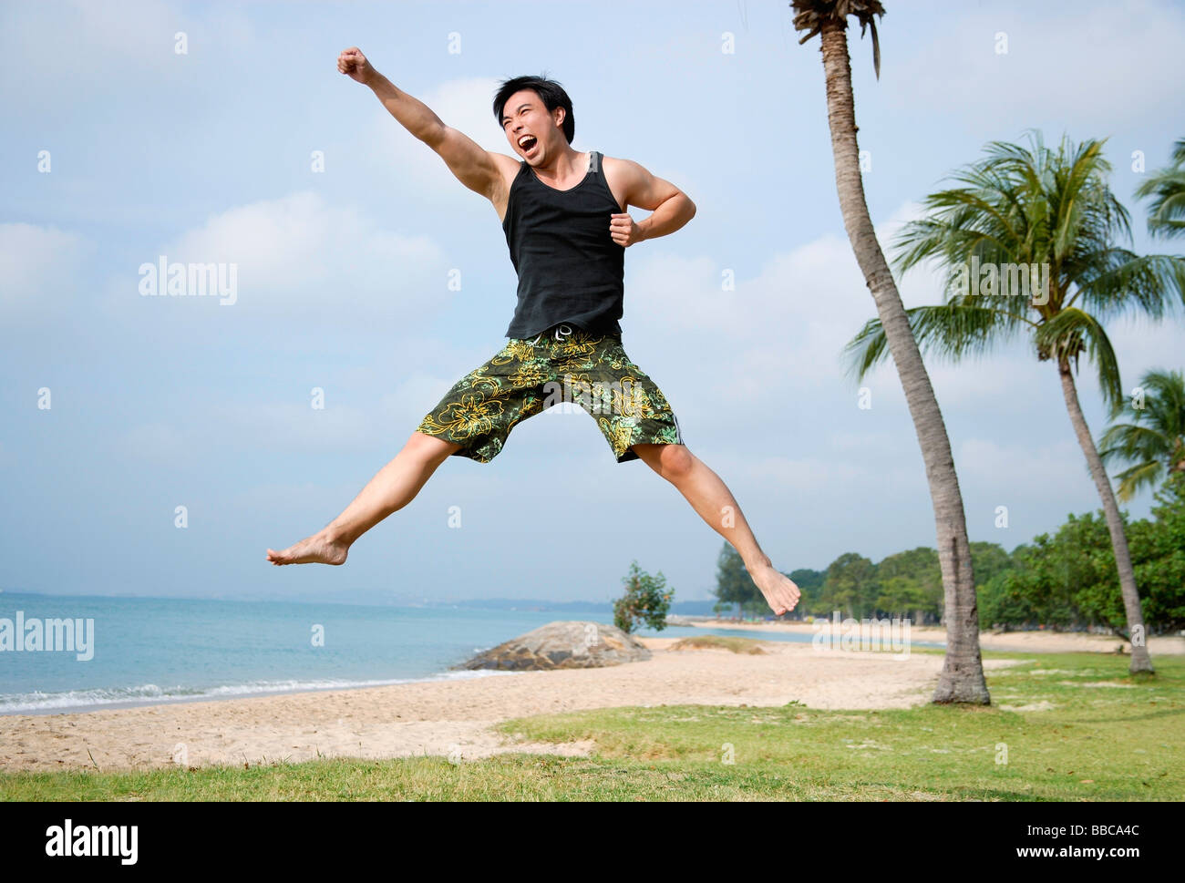 Man jumping in air, arms outstretched Stock Photo - Alamy