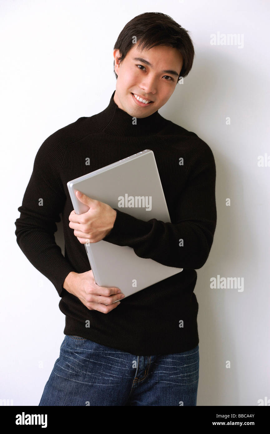 Man hugging laptop, laughing Stock Photo - Alamy