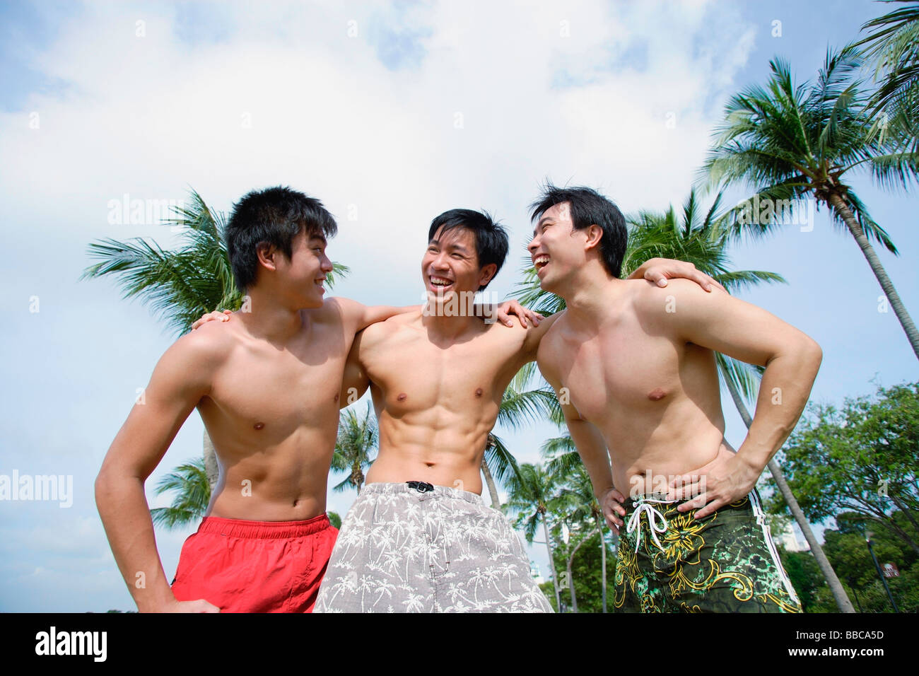 Three men with arms around each other Stock Photo - Alamy