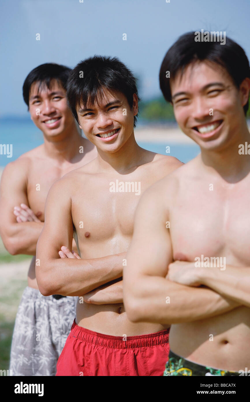 Three men with arms crossed, in a row Stock Photo - Alamy