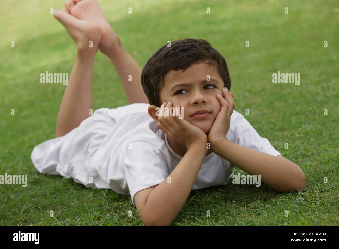 Little boy relaxing in park Stock Photo - Alamy