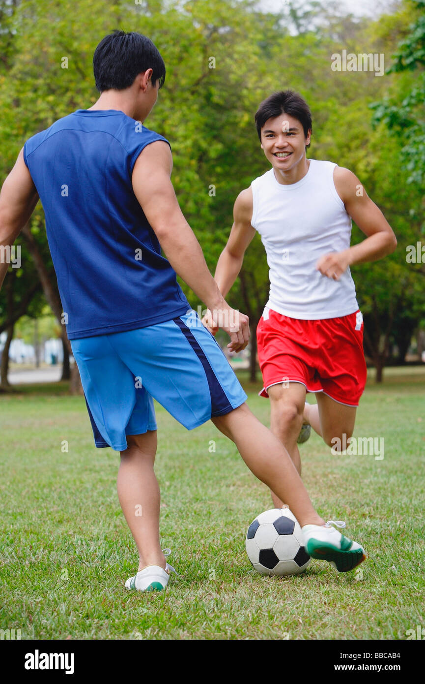 Two men in park, playing soccer Stock Photo - Alamy