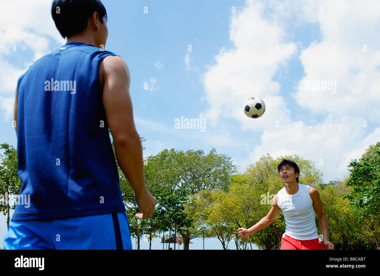 Two men playing soccer Stock Photo - Alamy