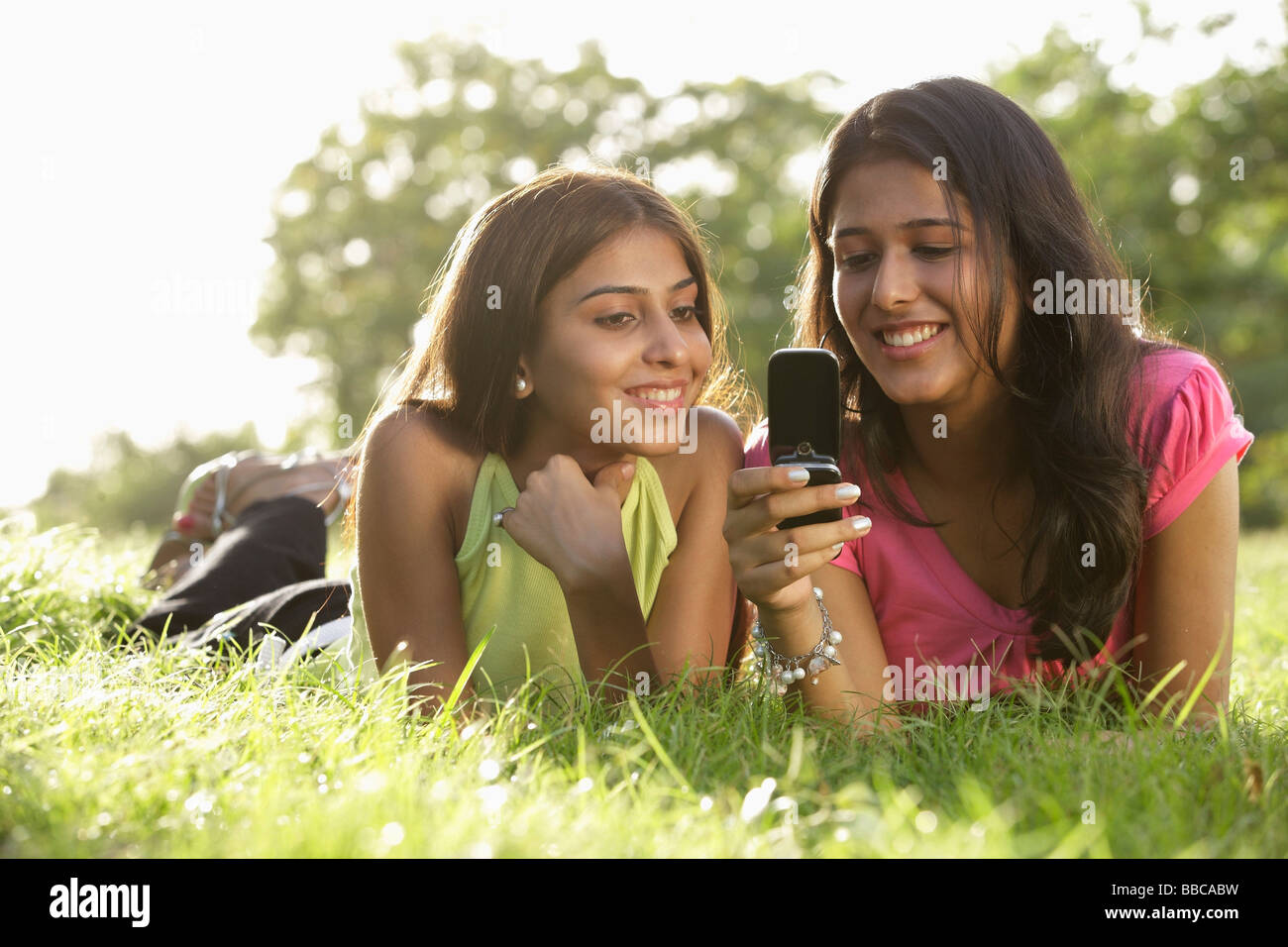 Teen girls reading text messages Stock Photo - Alamy