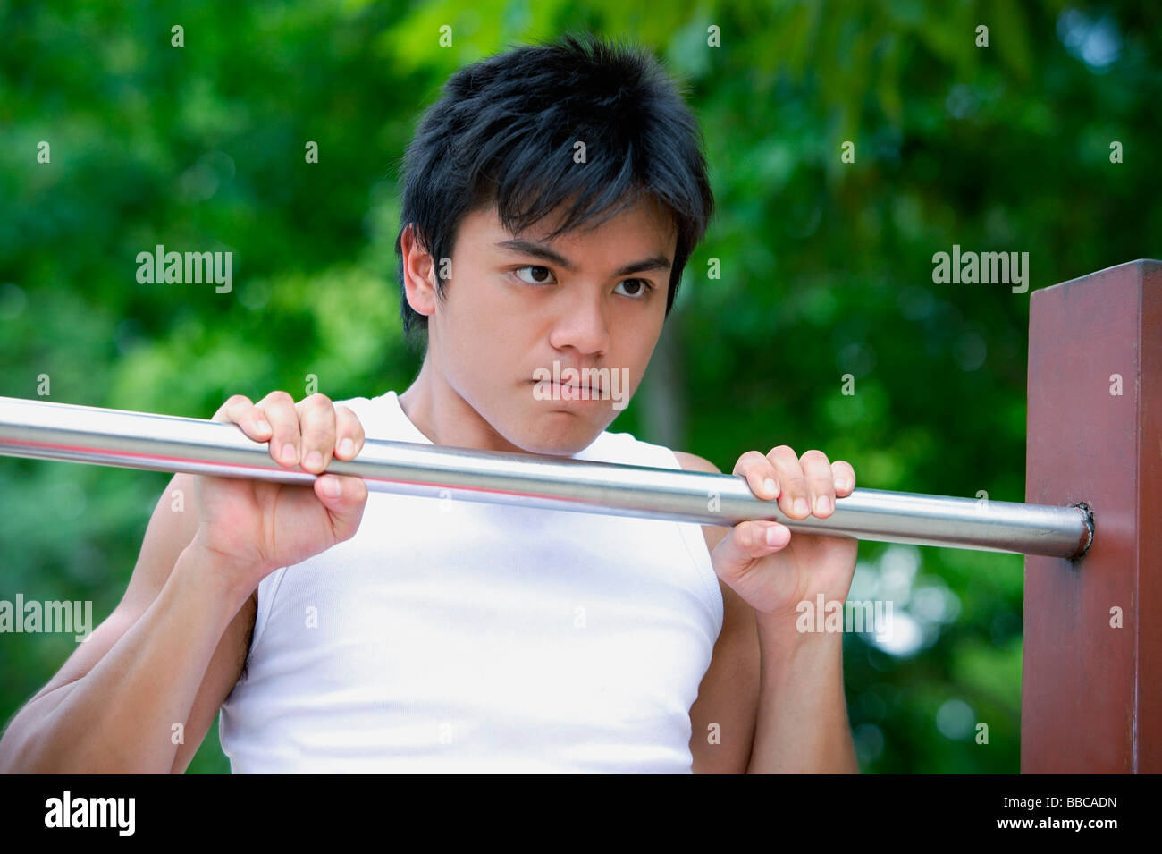 Young man doing chin-ups Stock Photo - Alamy