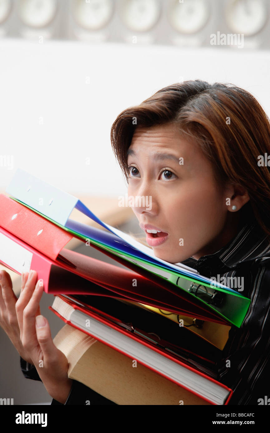 Female executive carrying folders and binders hi-res stock photography ...