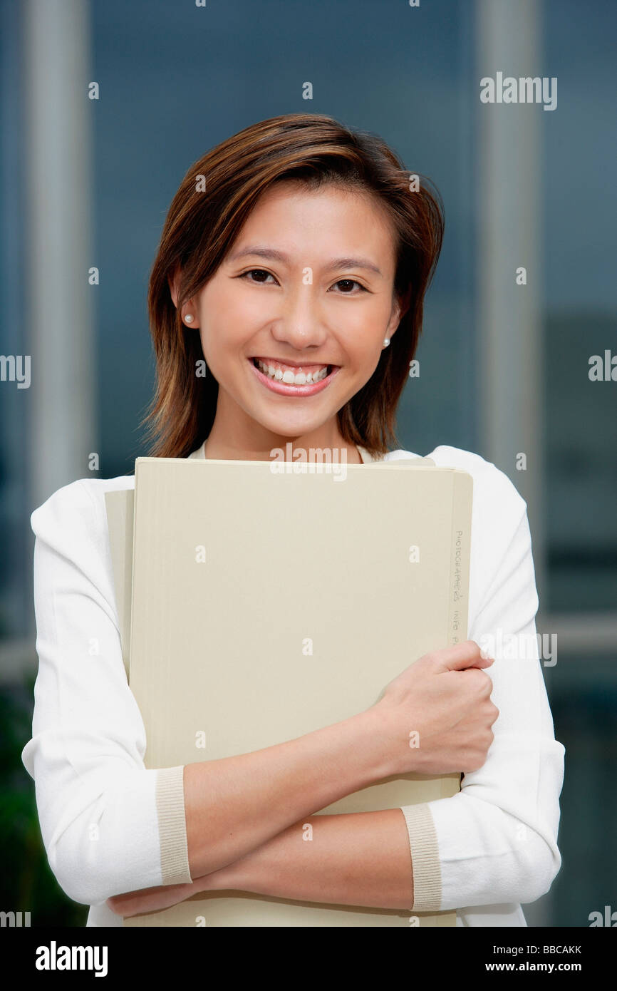Female executive hugging folders hi-res stock photography and images ...