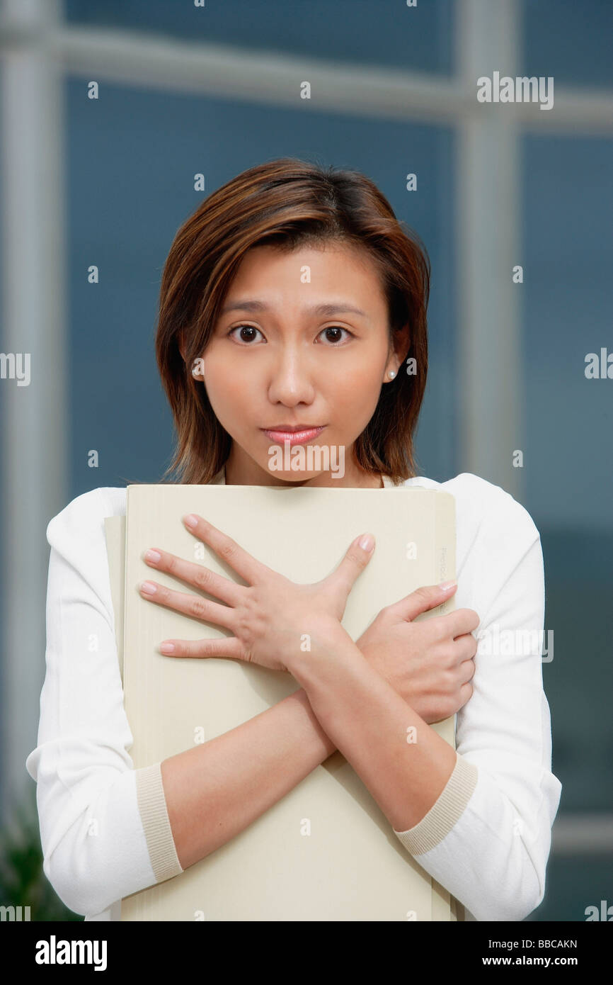 Female executive hugging folders, sad expression Stock Photo - Alamy