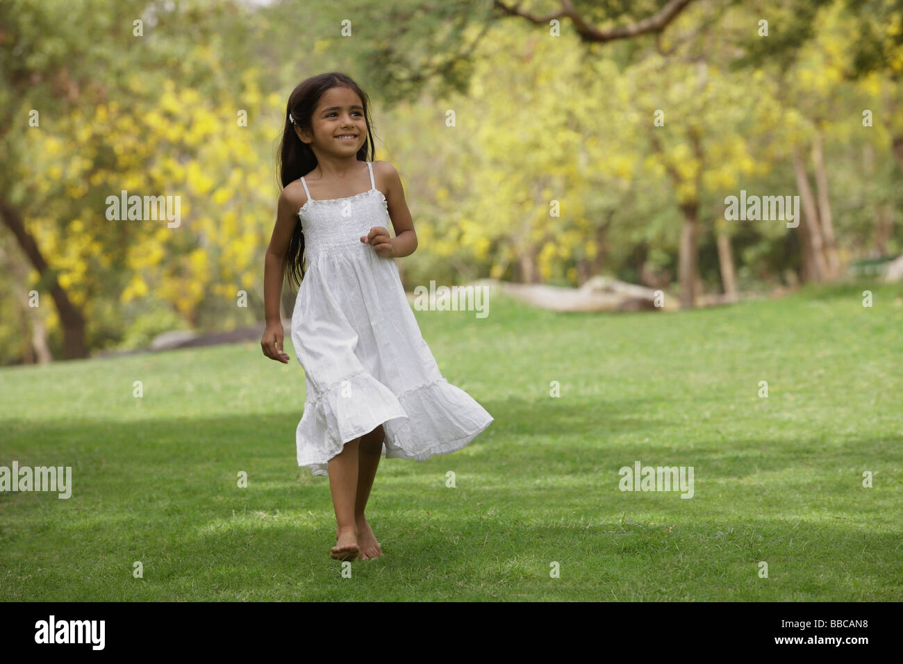 Little girl running in park Stock Photo - Alamy