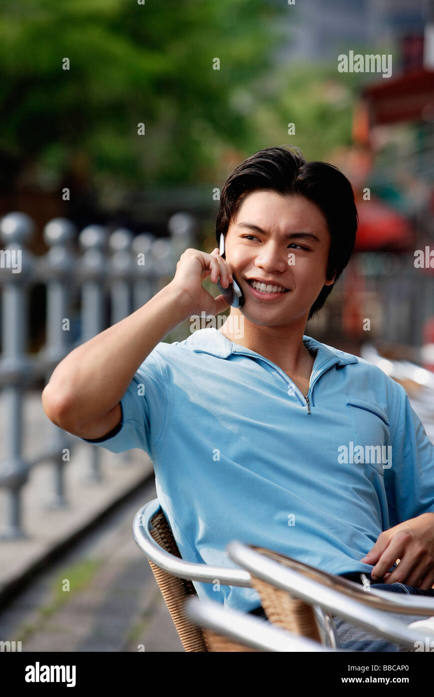 Man sitting outdoors, using mobile phone Stock Photo - Alamy