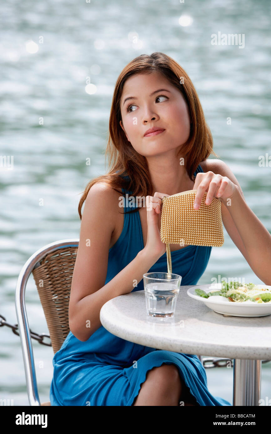 Woman and holding purse and pensive hi-res stock photography and images ...