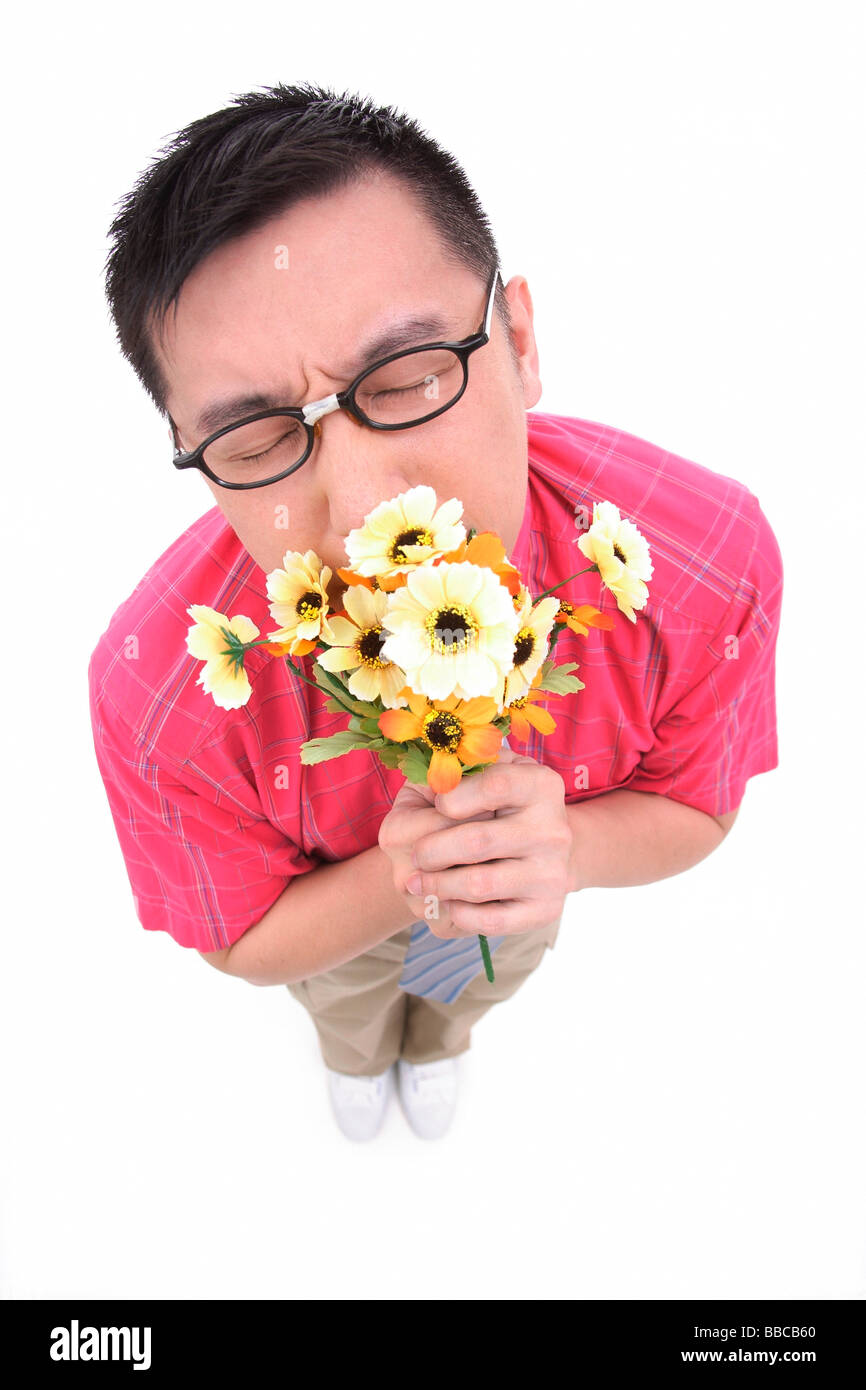 Man smelling flower bouquet Stock Photo - Alamy