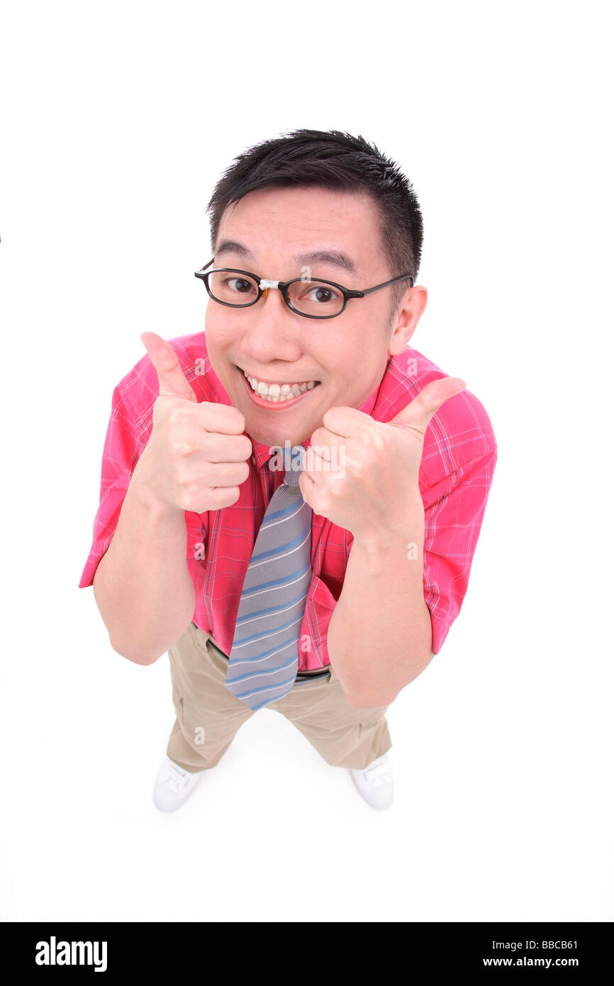 Man making thumbs up sign, smiling at camera Stock Photo - Alamy