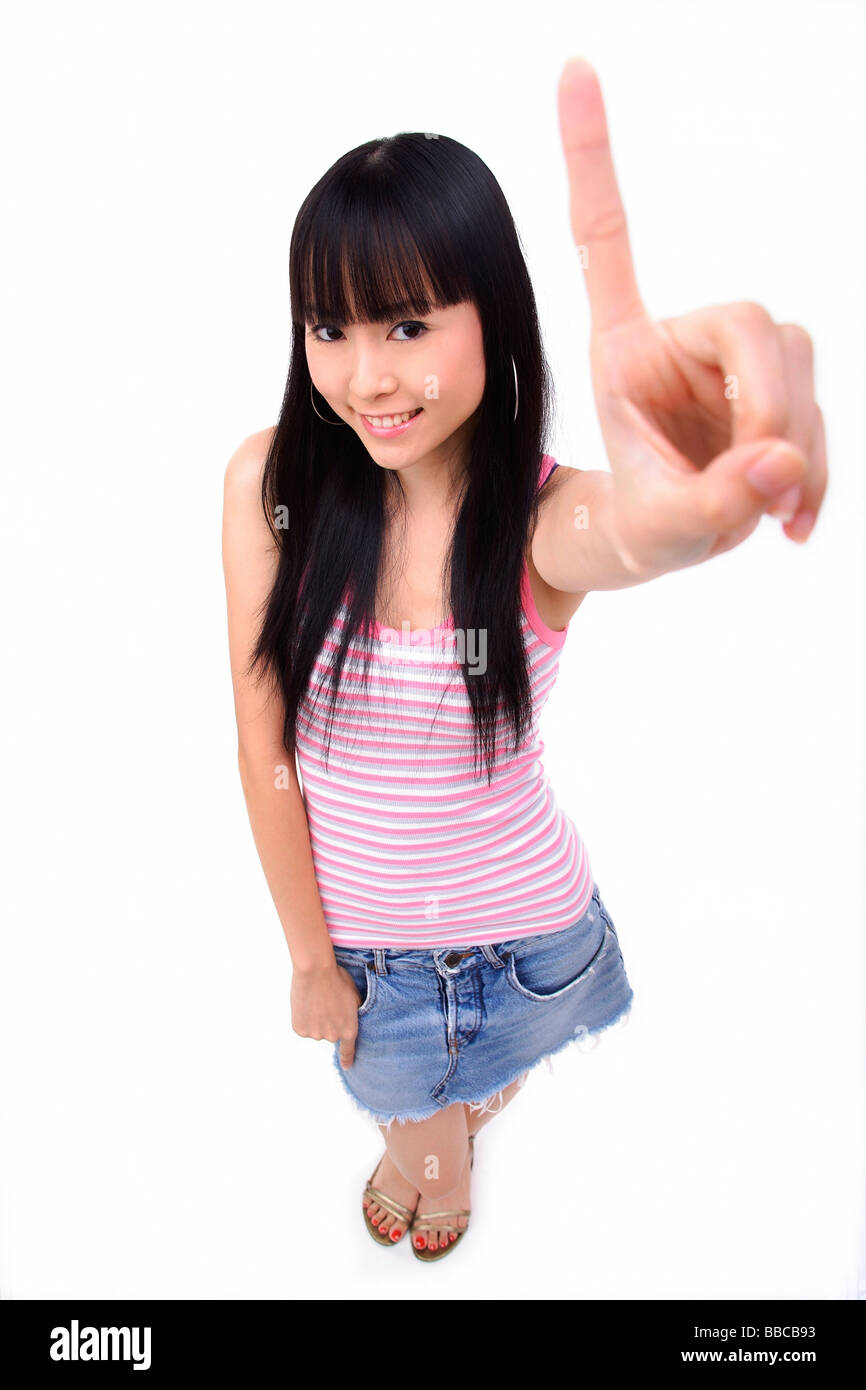Young woman making hand sign Stock Photo - Alamy
