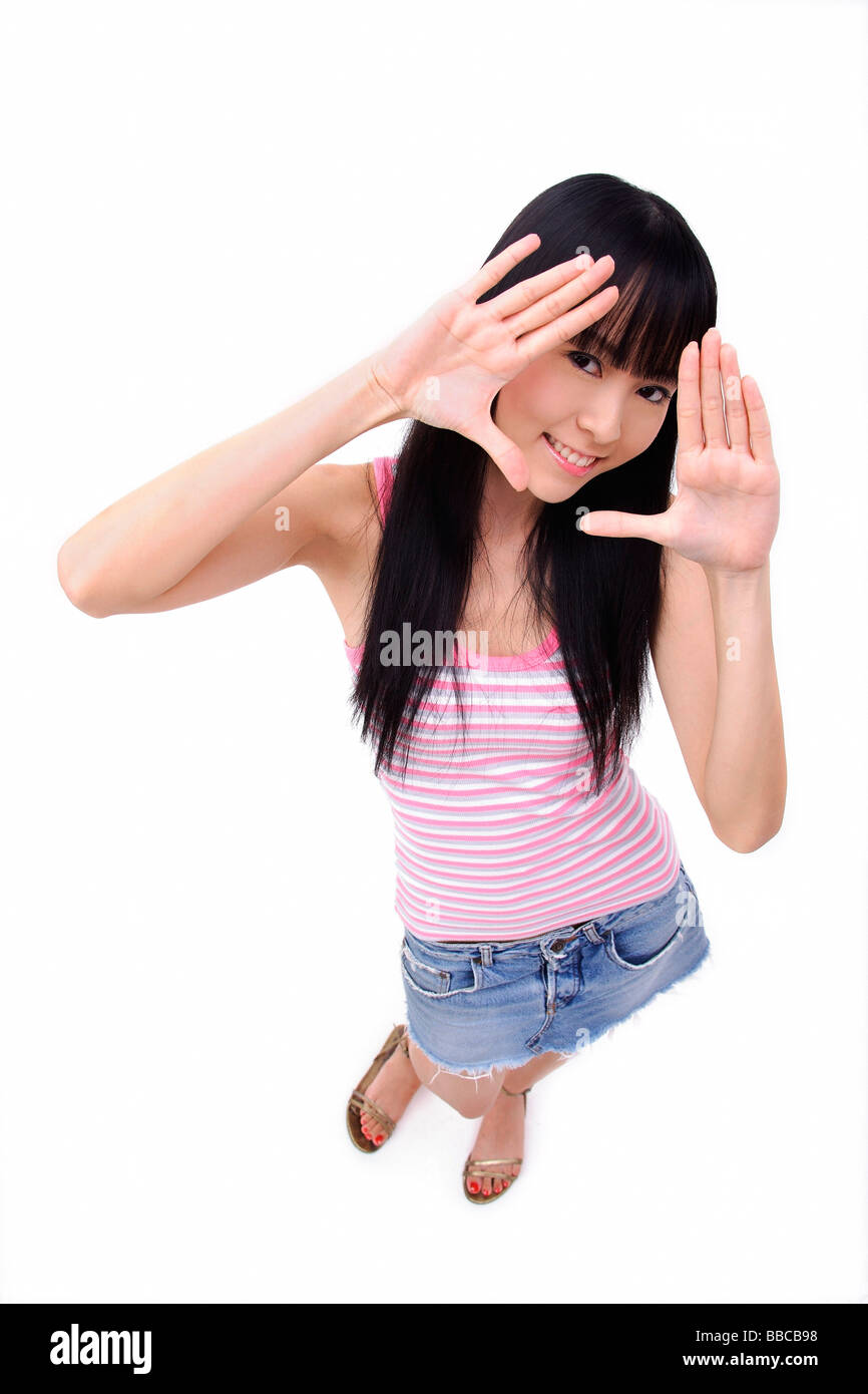 Young woman making hand frame, looking at camera Stock Photo - Alamy