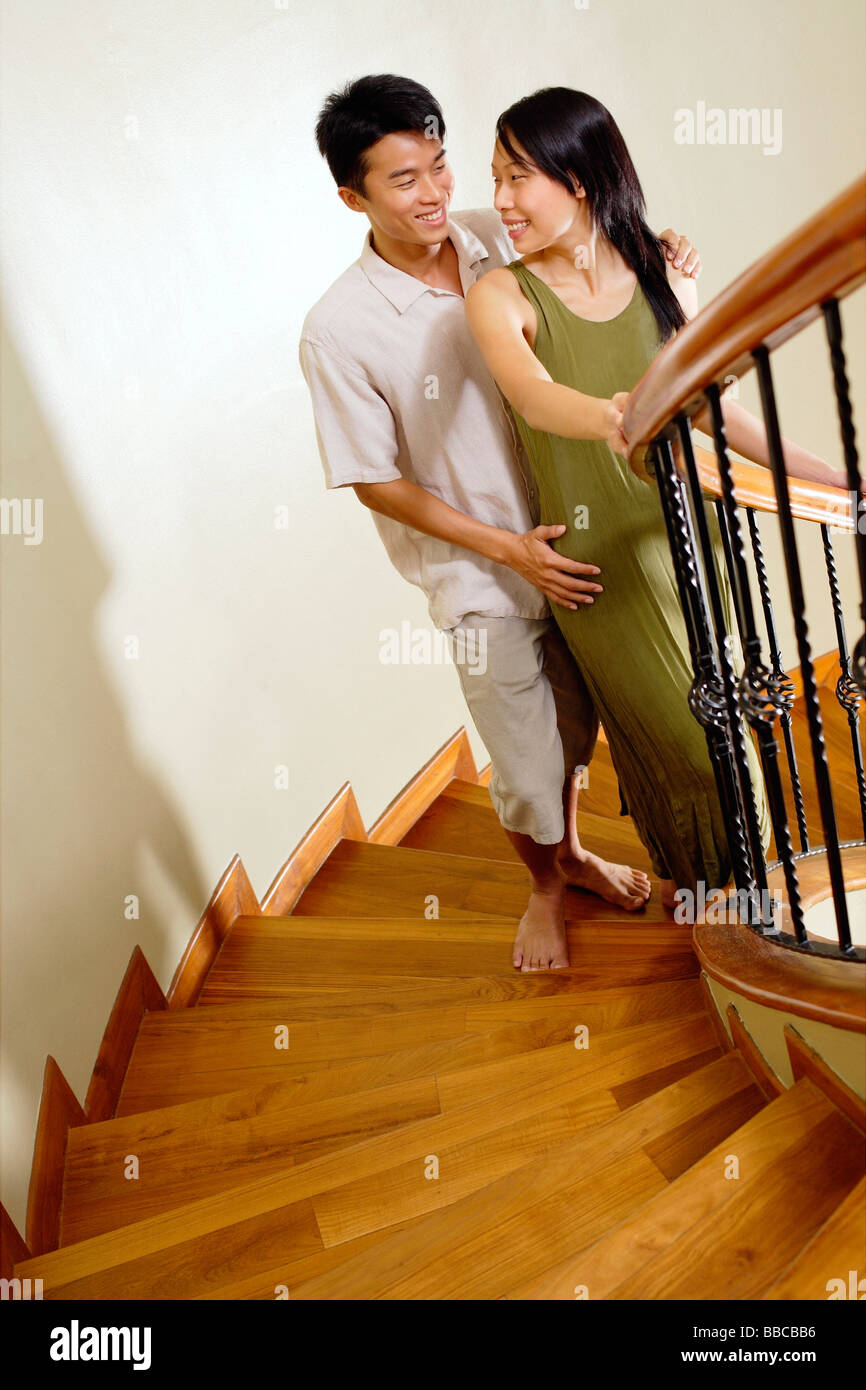 Couple on staircase Stock Photo - Alamy