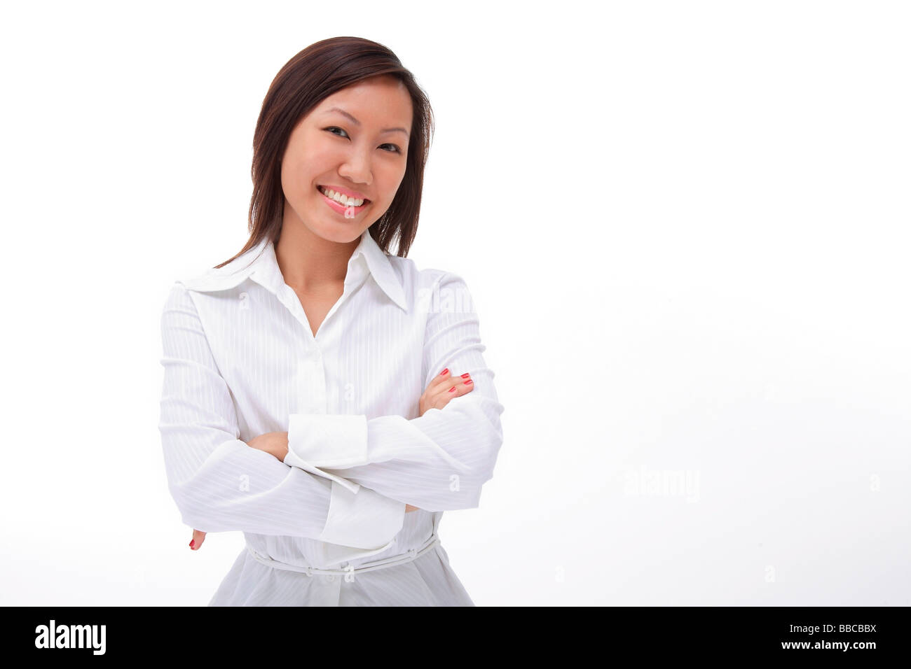 Woman with arms crossed, smiling at camera Stock Photo - Alamy