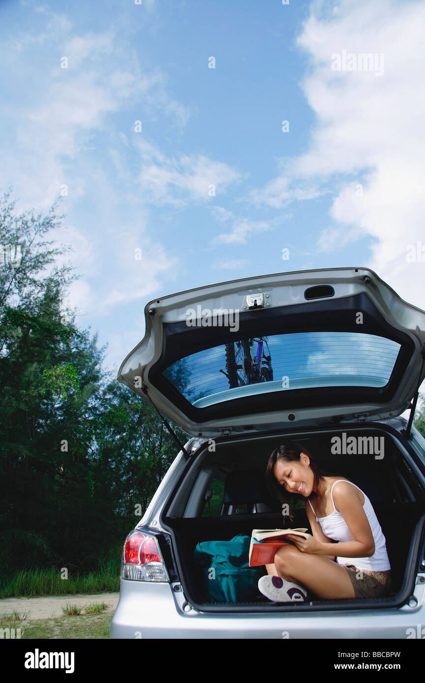 Woman reading magazine in car hi-res stock photography and images - Alamy