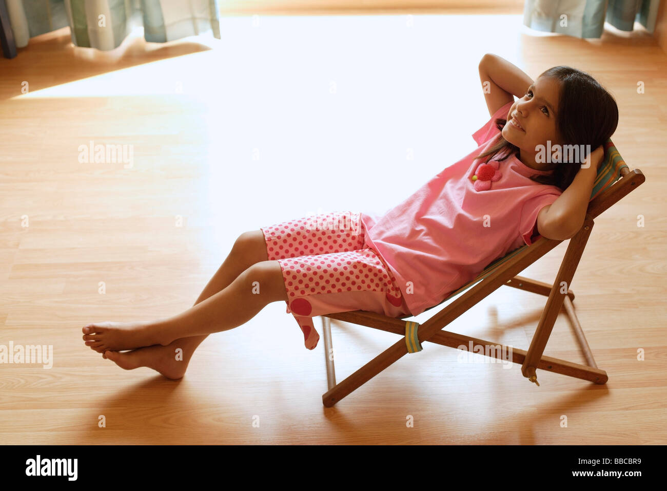 Little girl in chair Stock Photo - Alamy