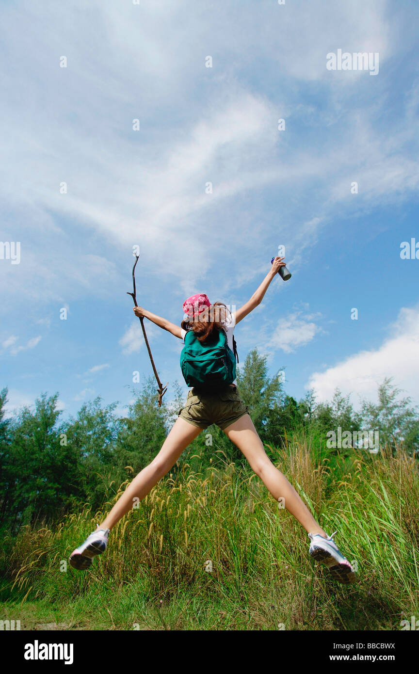 Female hiker, jumping, arms outstretched Stock Photo - Alamy