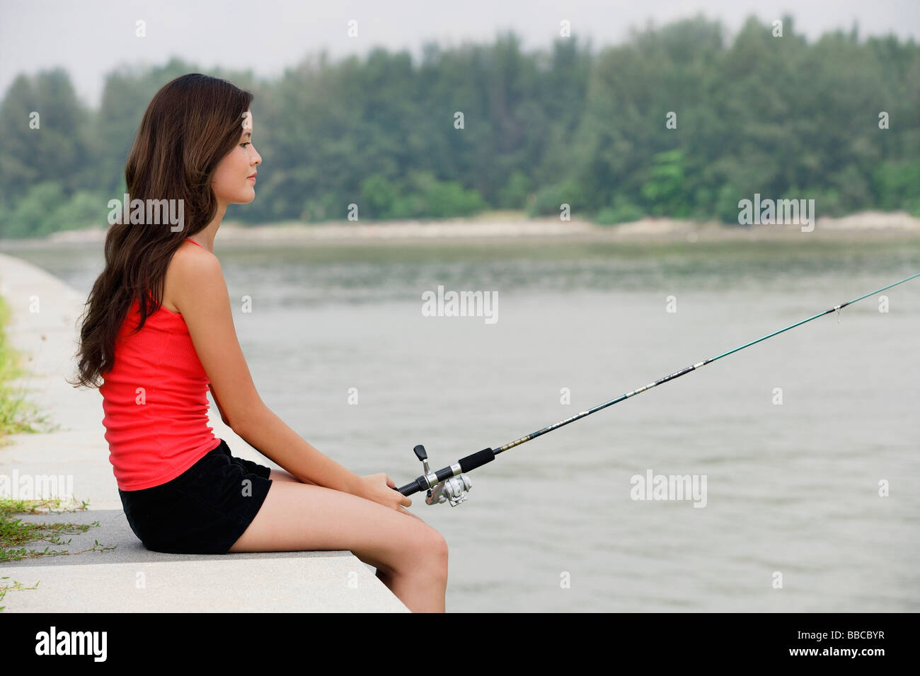 Young asian woman holding fishing hi-res stock photography and images ...