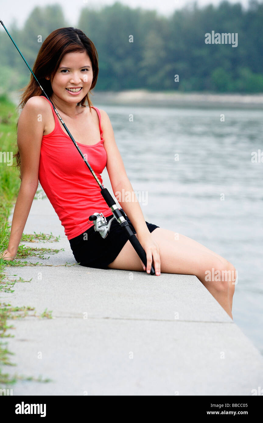 Young asian woman holding fishing hi-res stock photography and images ...