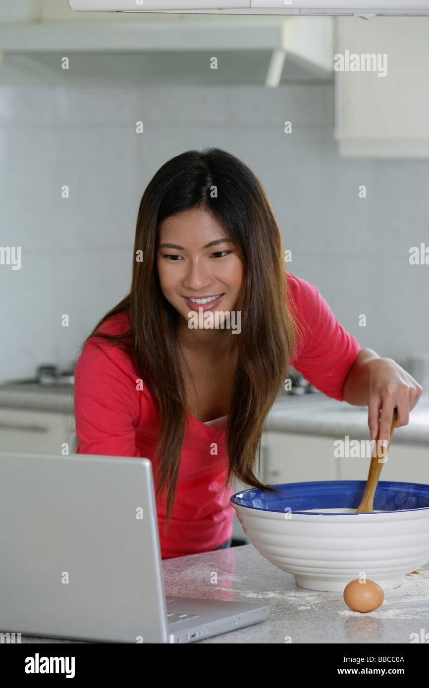 Woman reading recipe on laptop Stock Photo - Alamy