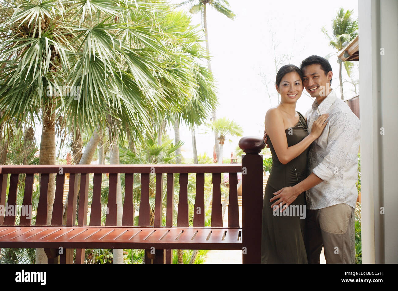 Couple standing cheek to cheek, embracing, smiling Stock Photo - Alamy