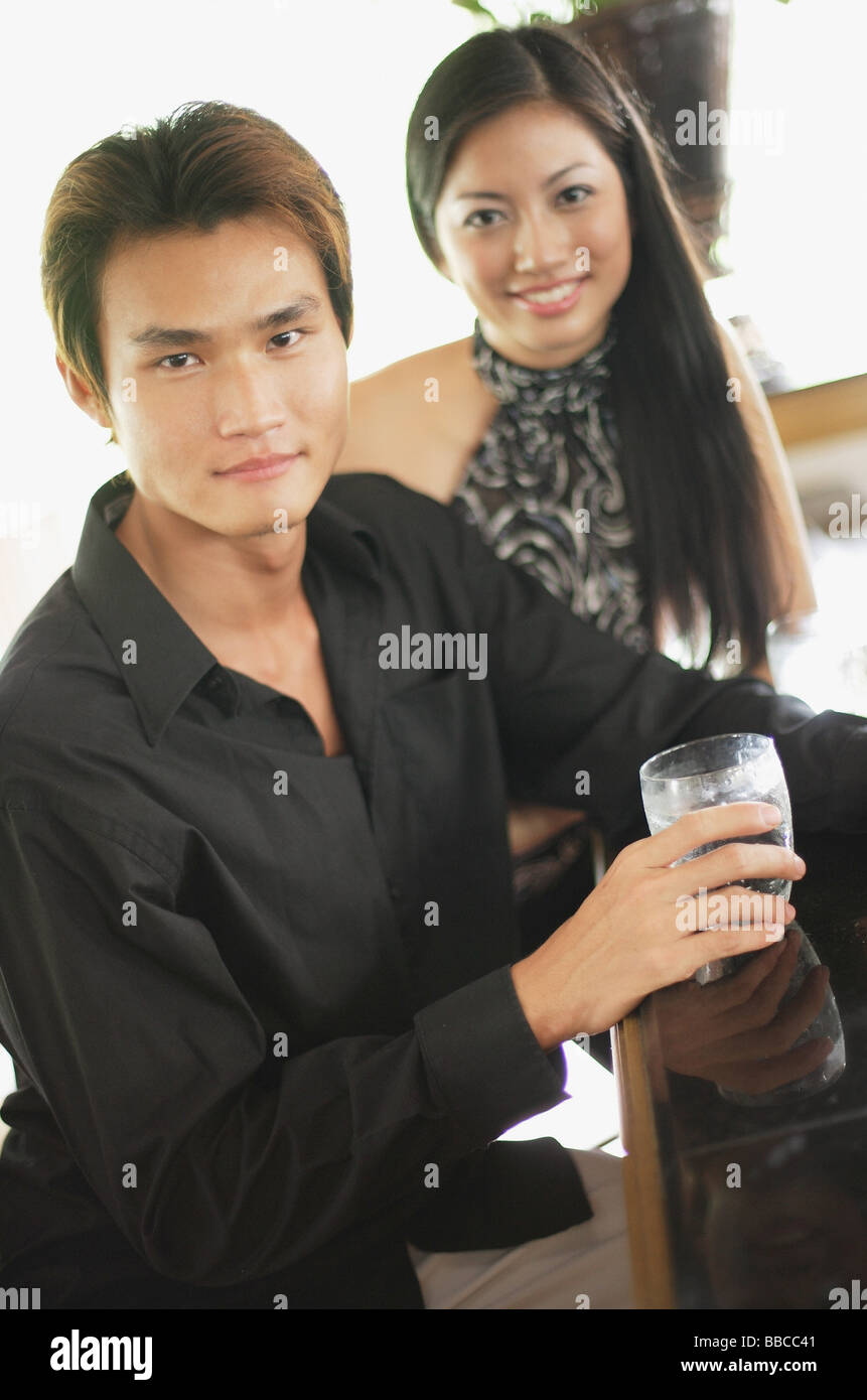 Couple sitting at bar counter, looking at camera, portrait Stock Photo ...