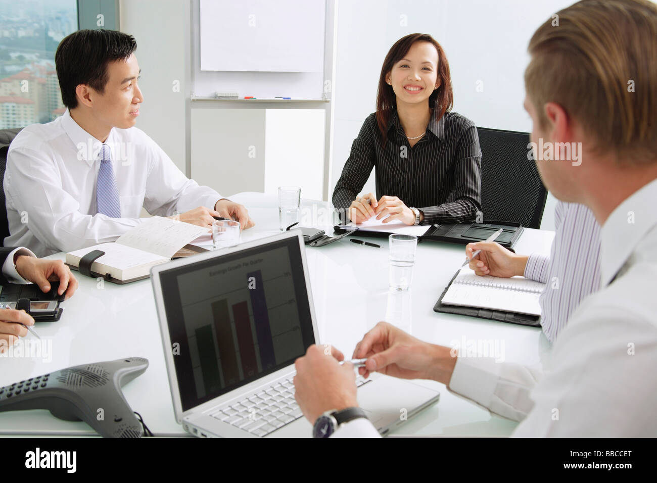 Executives sitting around conference table hi-res stock photography and ...