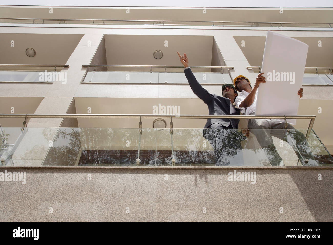 architects looking at plans Stock Photo - Alamy