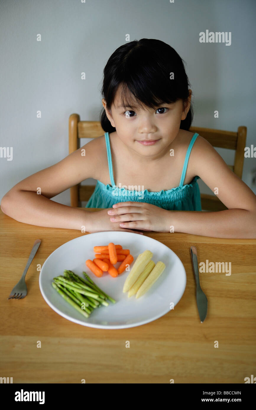 Little girl with plate of vegetables Stock Photo - Alamy
