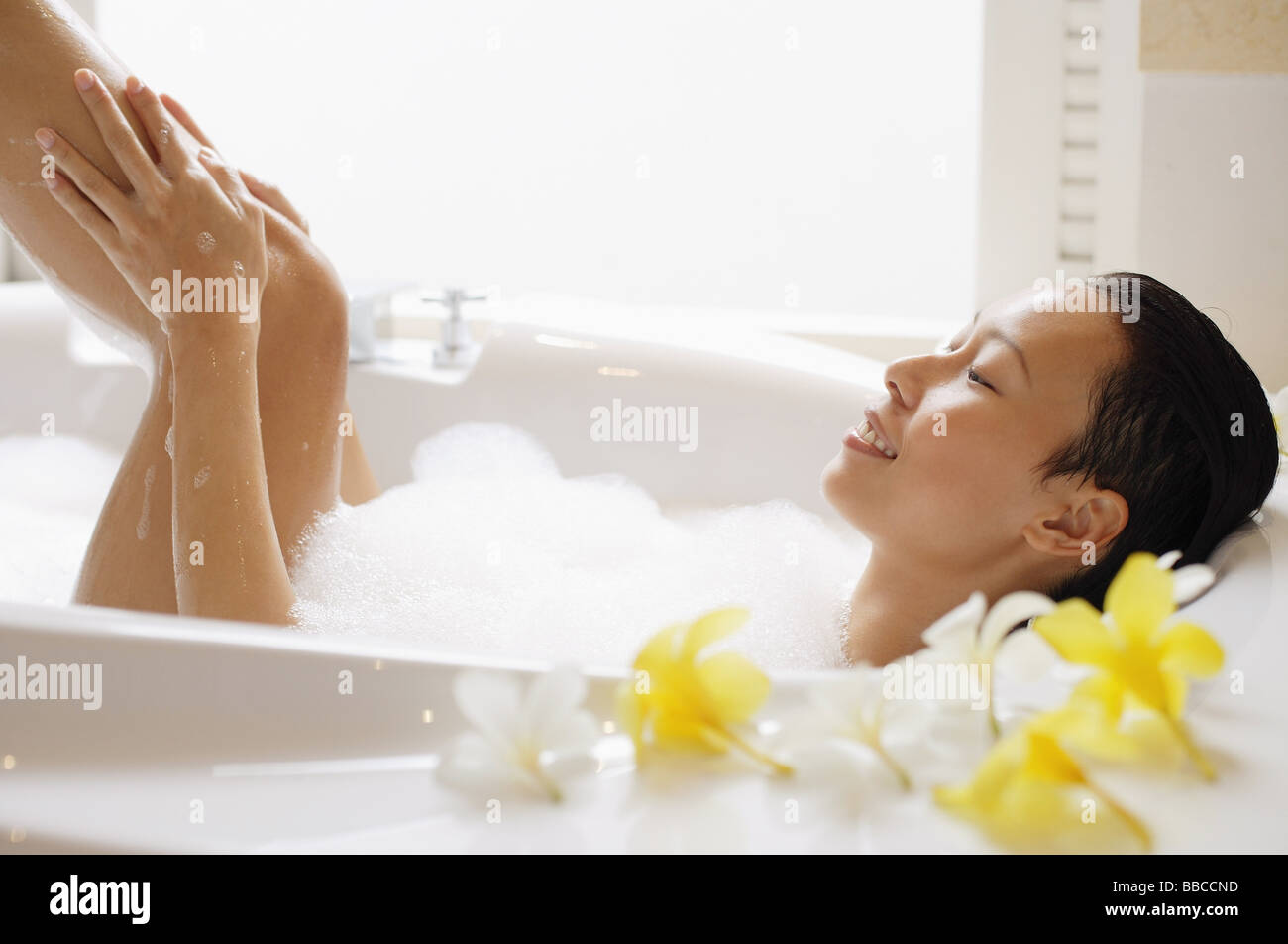Woman taking a bath, washing leg Stock Photo - Alamy