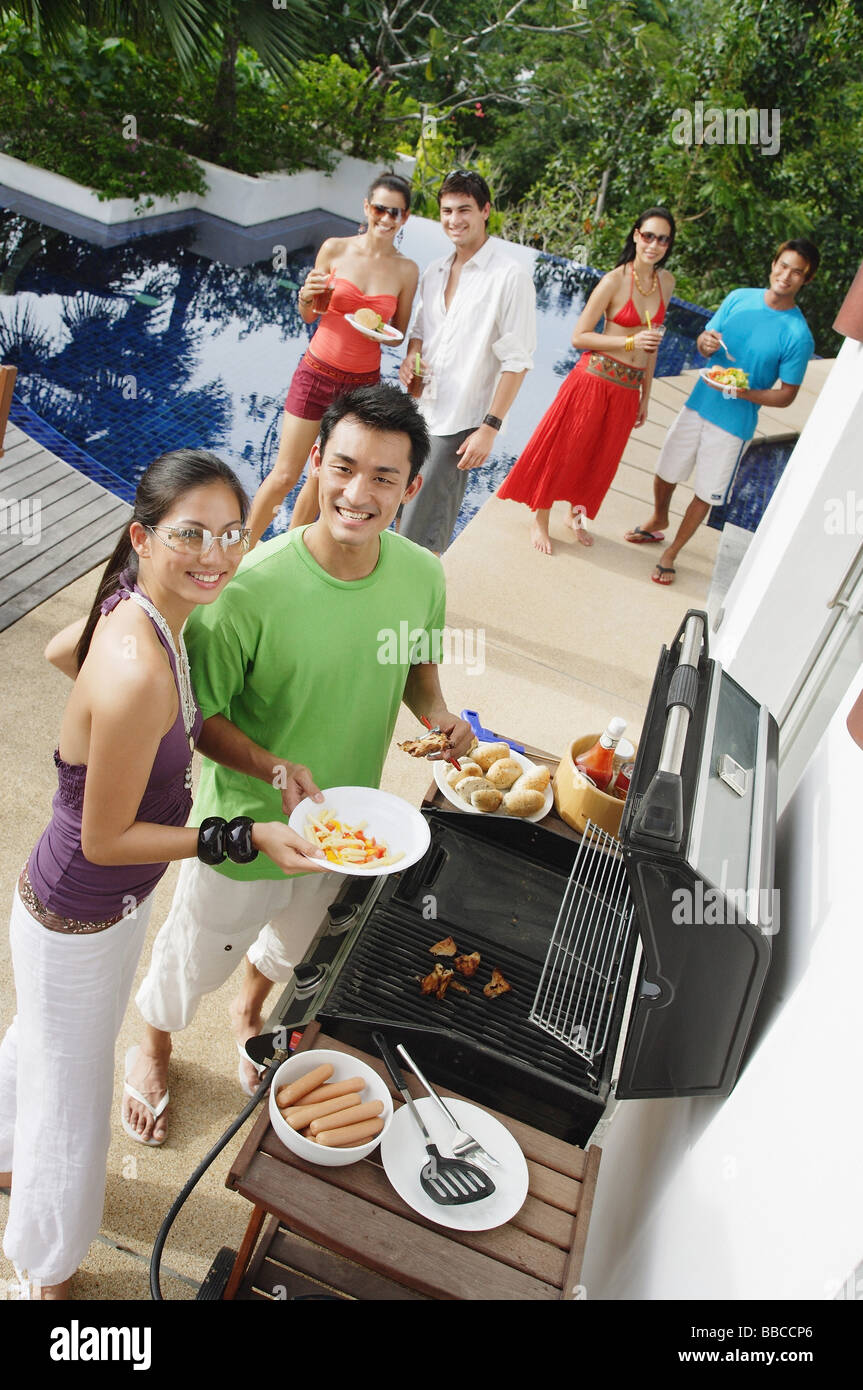 Friends at barbeque party, smiling at camera Stock Photo - Alamy