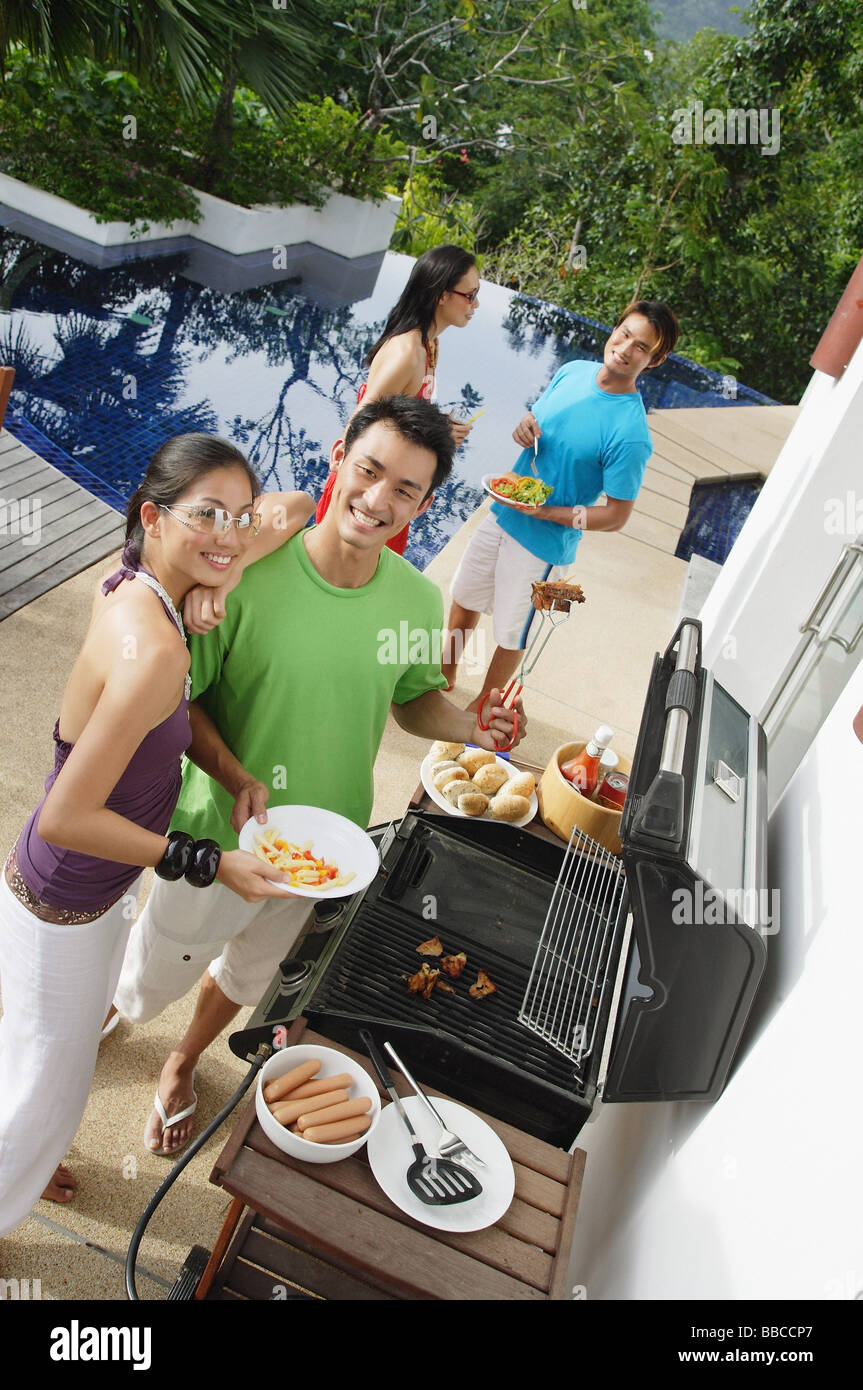 Couples at barbeque party Stock Photo - Alamy
