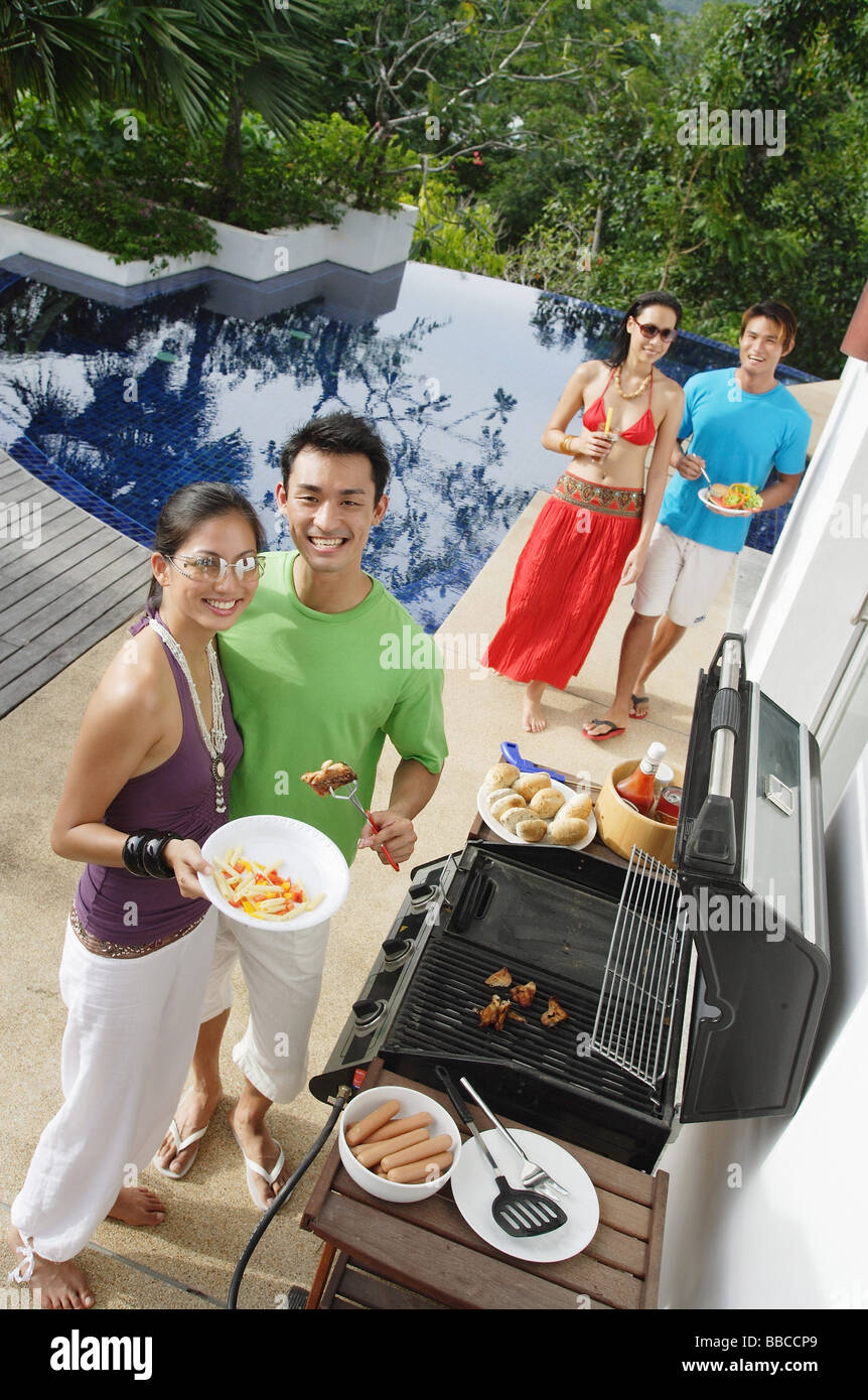 Couples at barbeque party, smiling at camera Stock Photo - Alamy
