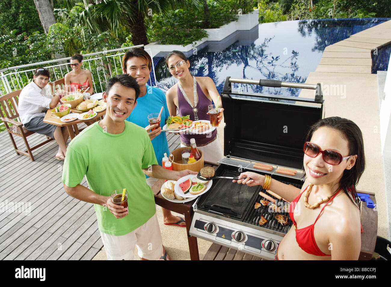 Friends at barbeque party, smiling at camera Stock Photo - Alamy