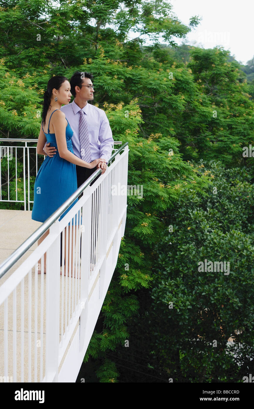 Couple standing on balcony, side view Stock Photo - Alamy