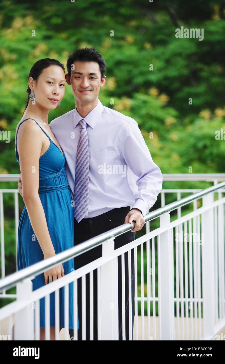 Couple standing together, side by side, looking at camera Stock Photo ...