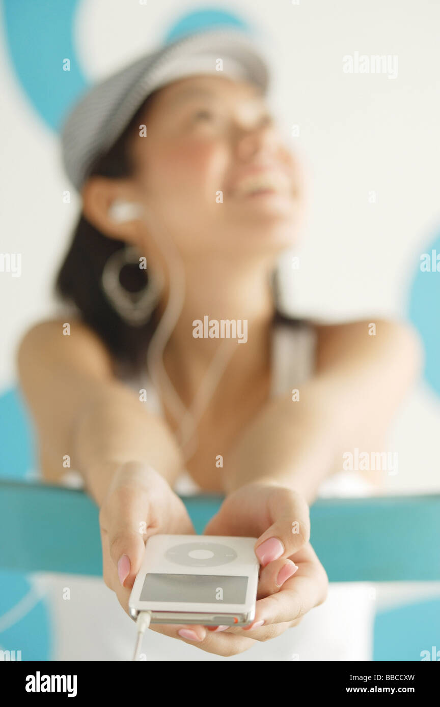 Young woman listening to MP3 player Stock Photo - Alamy