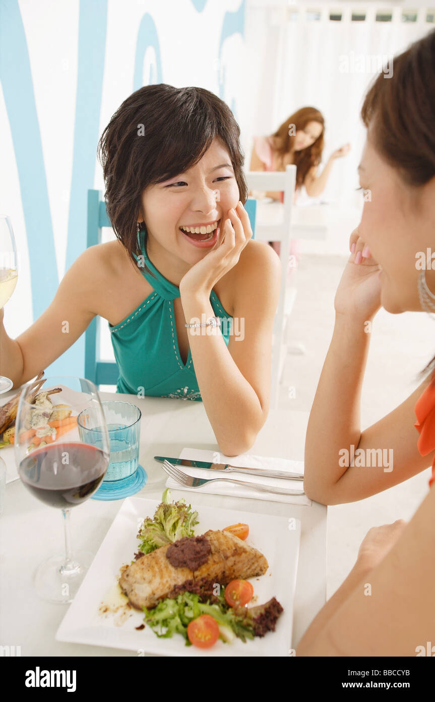 Young women talking over lunch in cafe Stock Photo - Alamy
