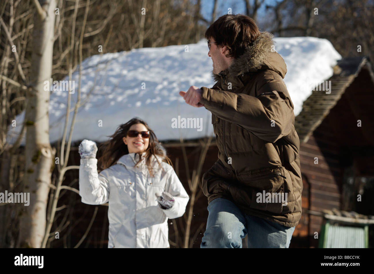 Young couple throwing snow in hi-res stock photography and images - Alamy