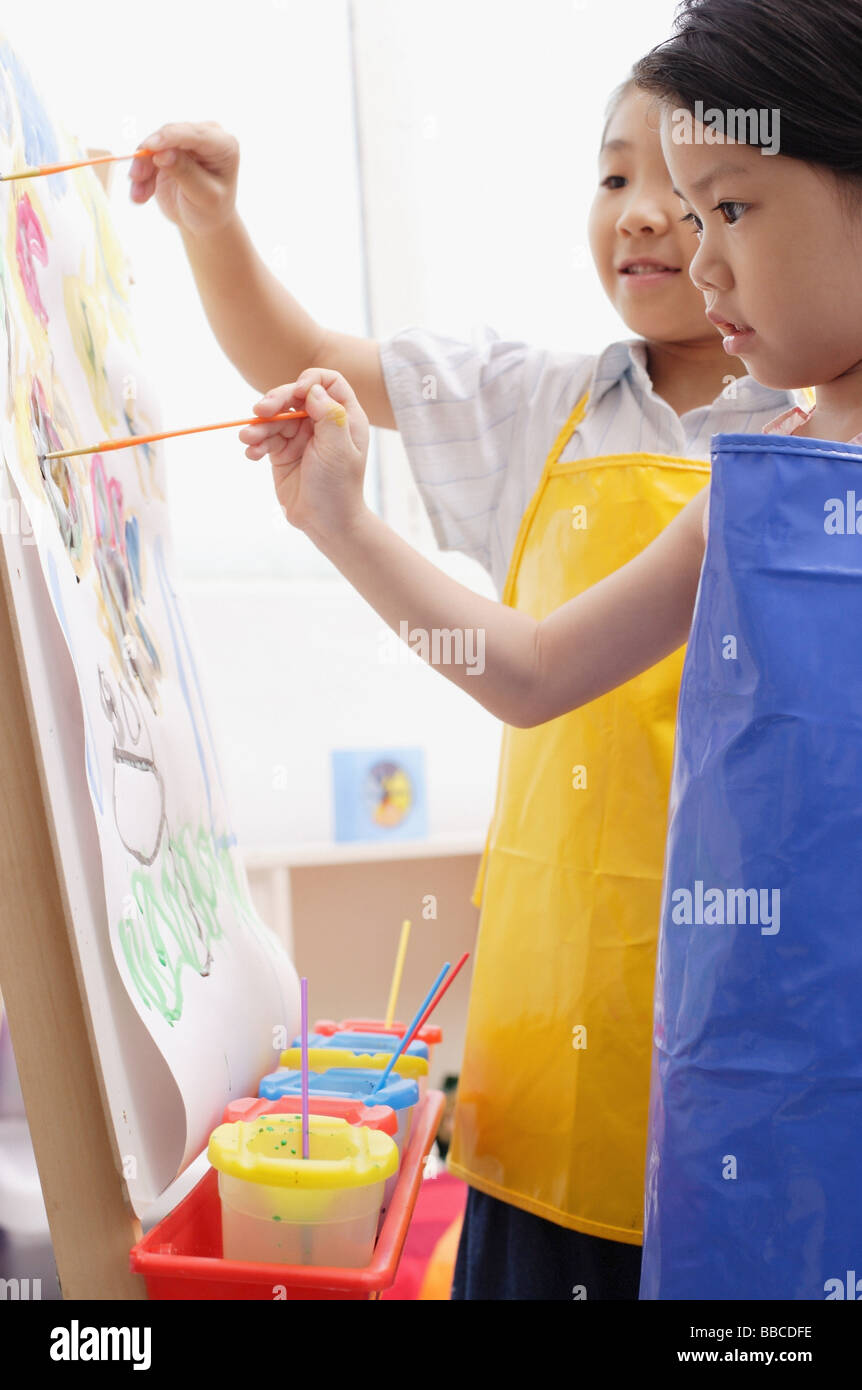 Two young girls painting Stock Photo - Alamy
