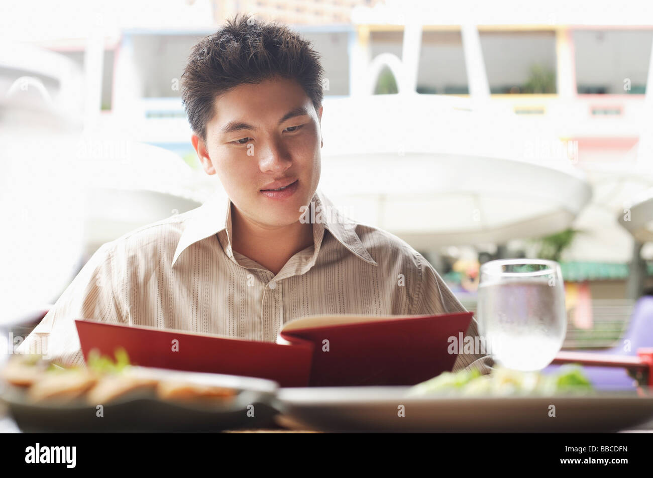 Man in cafe, looking at menu Stock Photo - Alamy