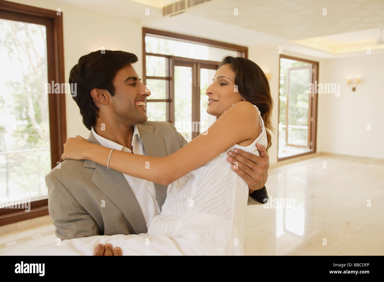 Young couple in empty home Stock Photo - Alamy