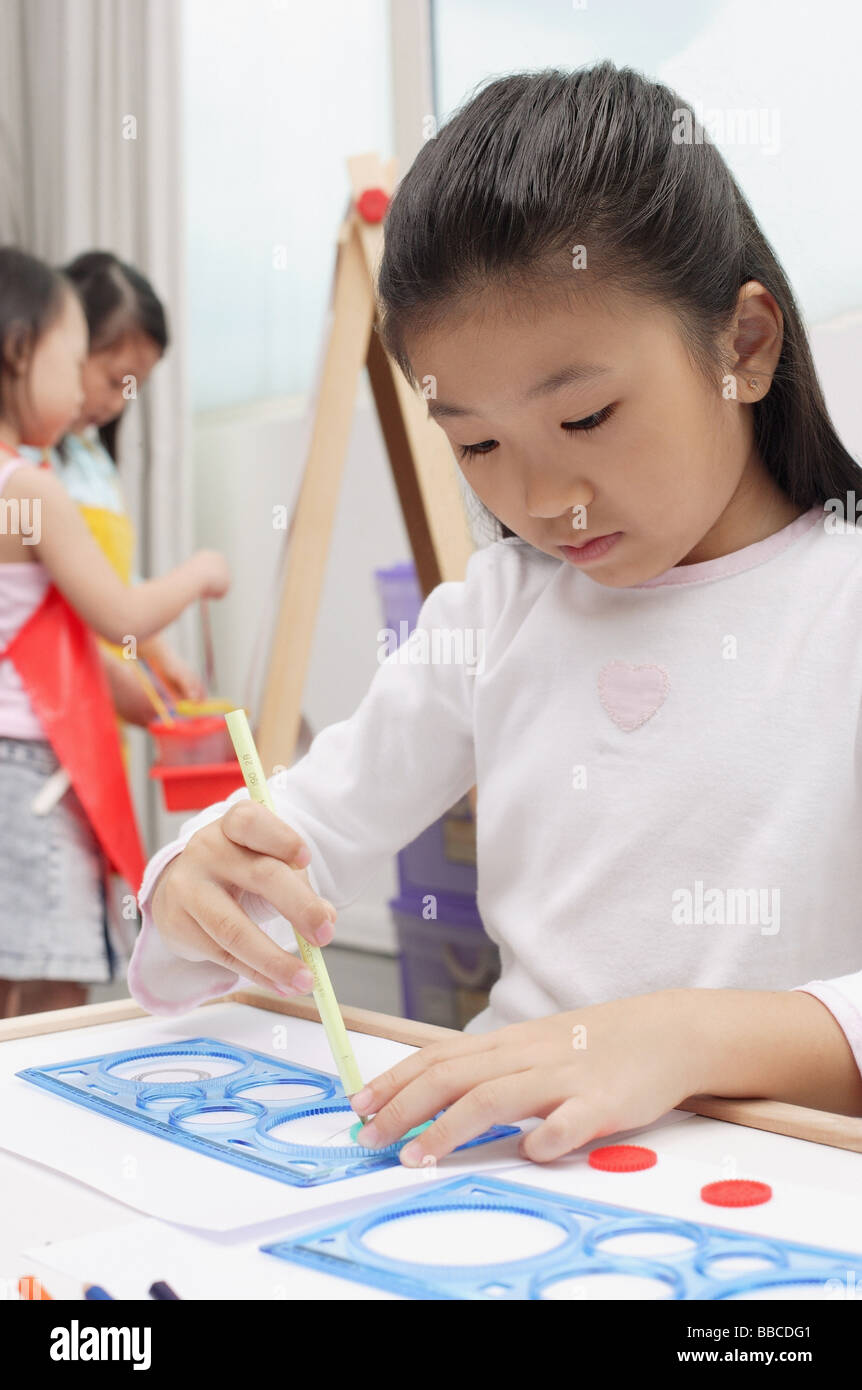 Girl drawing with stencil Stock Photo - Alamy