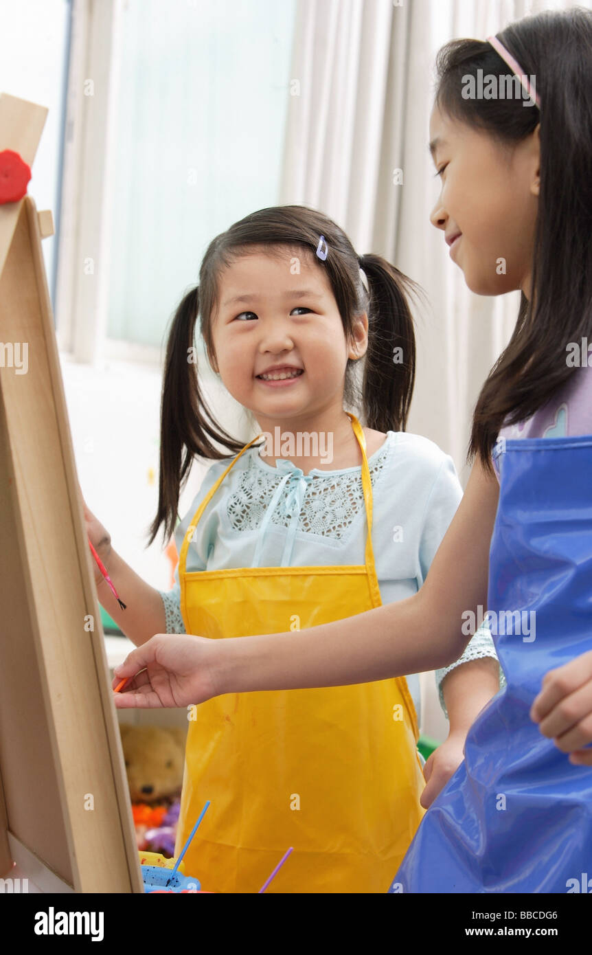 Two girls painting on easel hi-res stock photography and images - Alamy