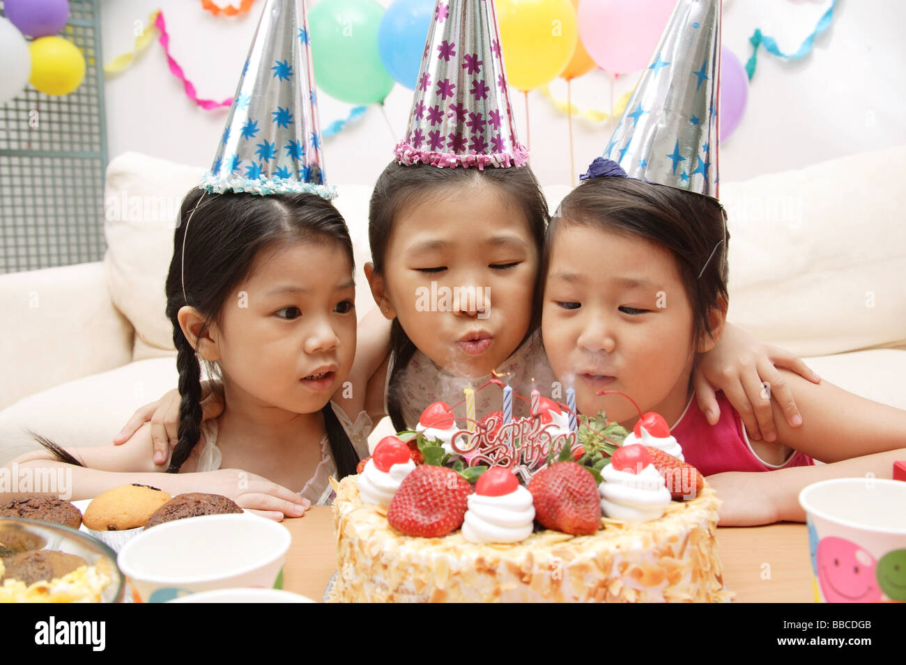 Three girls celebrating a birthday Stock Photo - Alamy